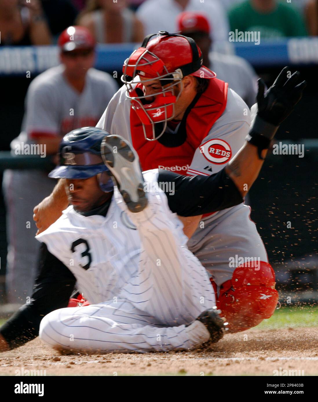 Cincinnati Reds catcher Corky Miller, back, turns to apply the tag as ...