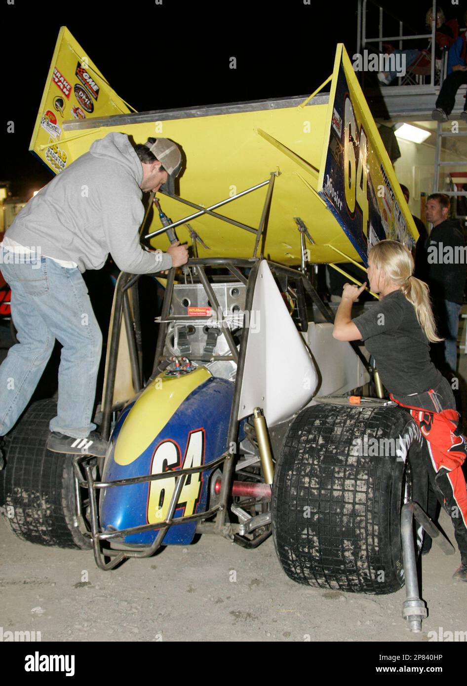 American Sprint Car Series driver Jessica Zemken works on her car with ...
