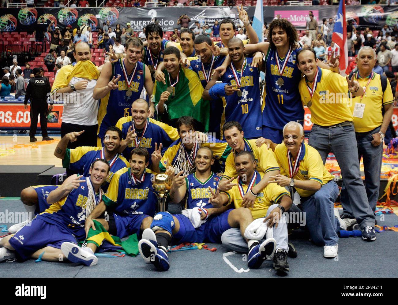 Brazil's basketball team players pose with their medals and trophy ...
