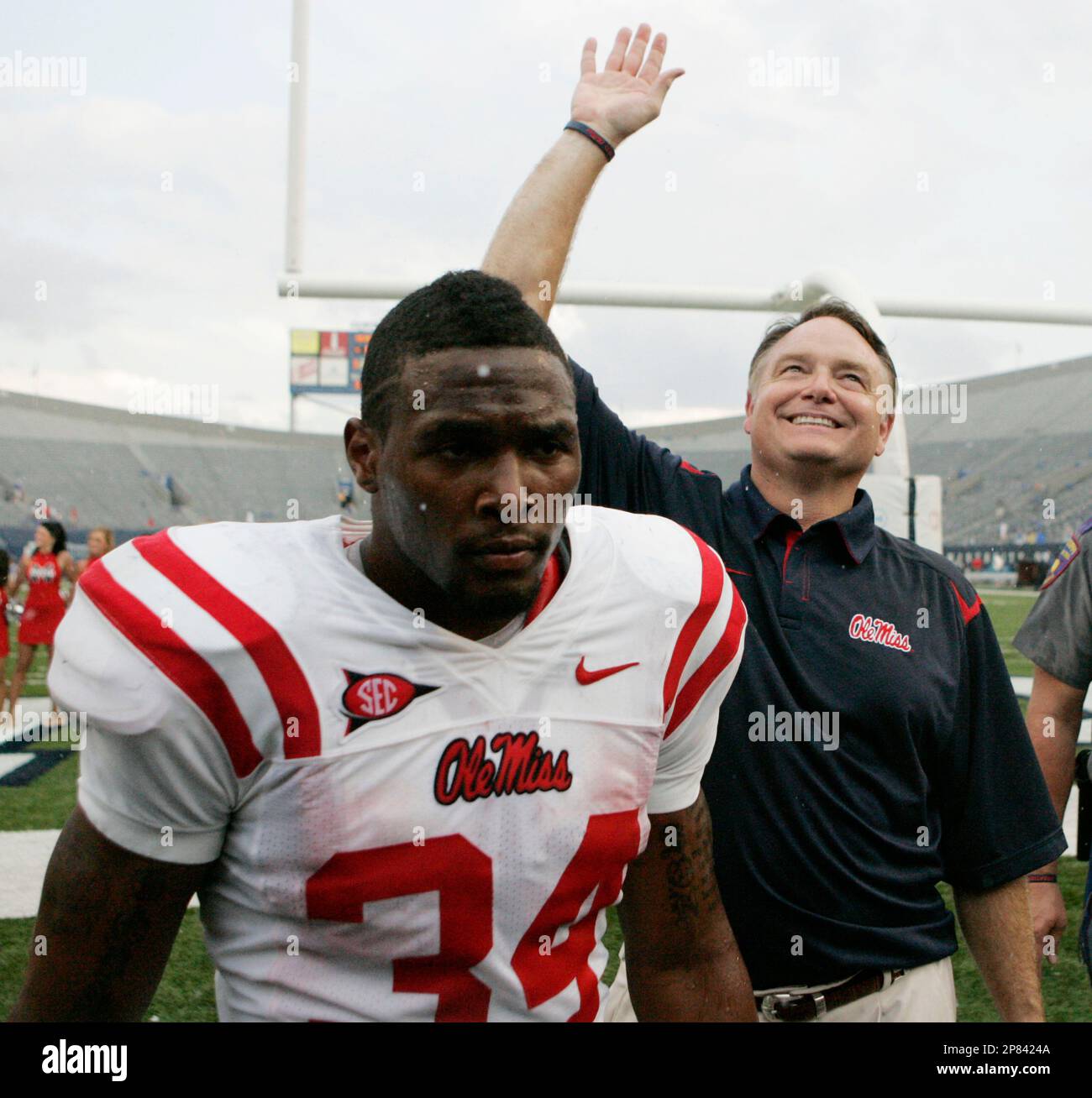 Mississippi coach Houston Nutt waves to fans as he and Brandon Bolden ...