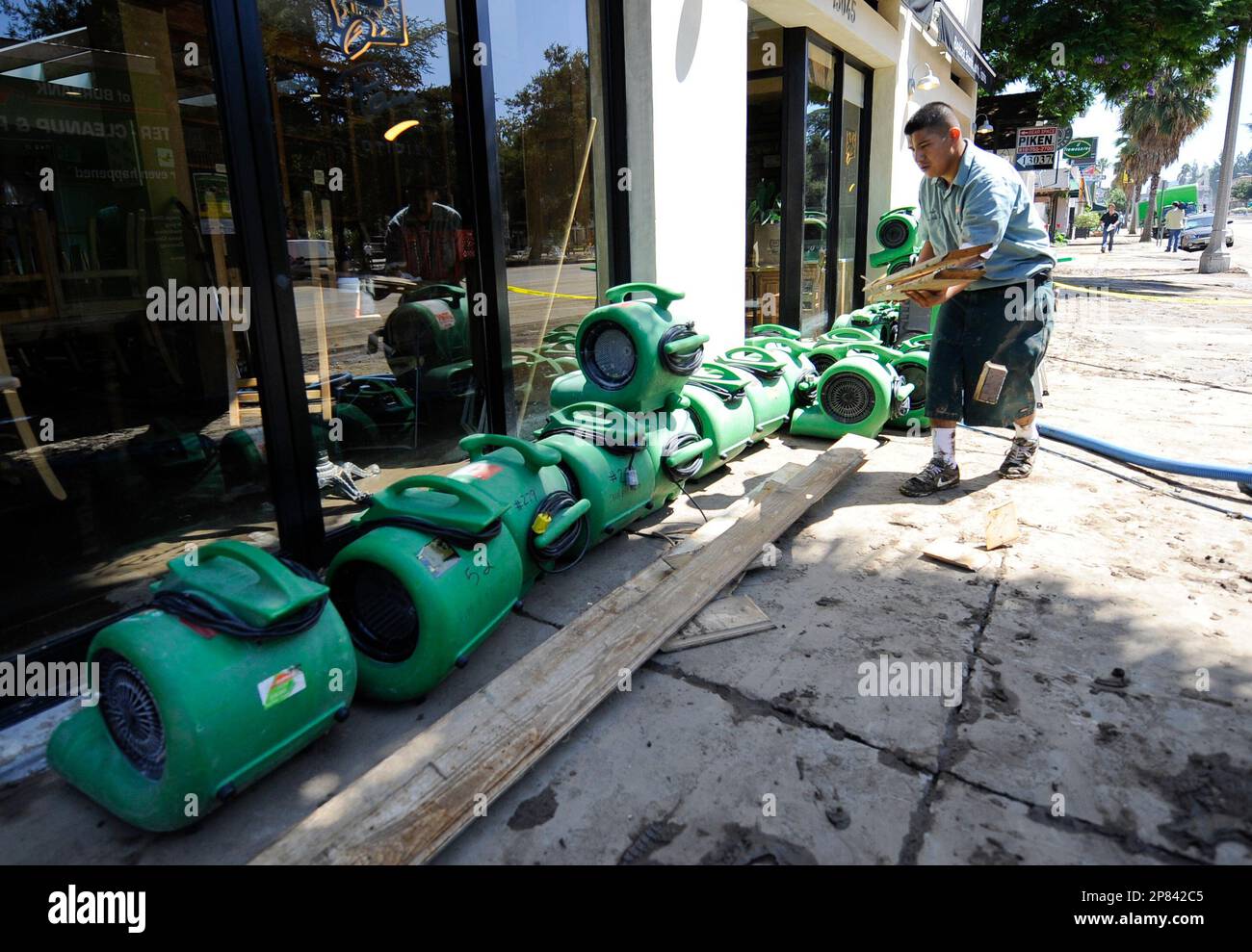 Drying fans stand at the ready as water damage crews clean up water ...