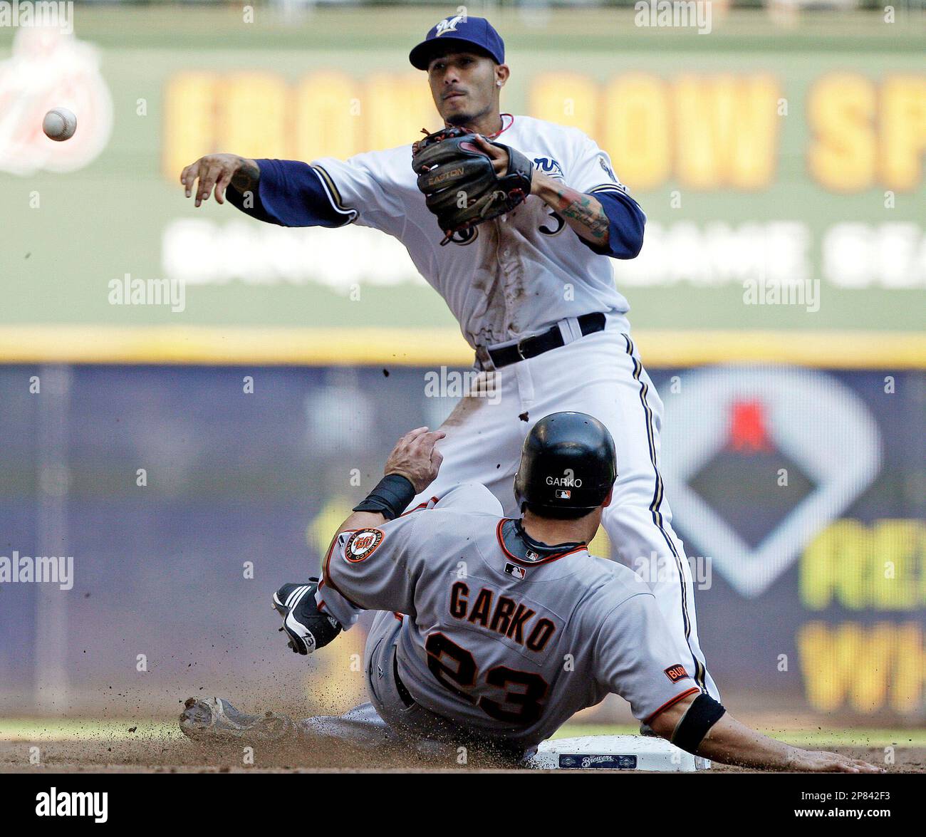 Milwaukee Brewers' Felipe Lopez (3) throws to first to complete a ...