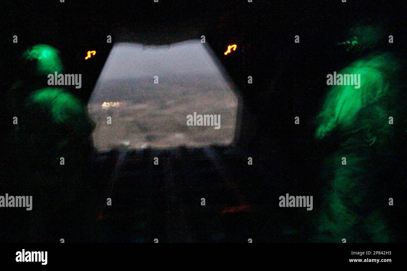 The ground is seen out of the back of a special operations plane as it ...