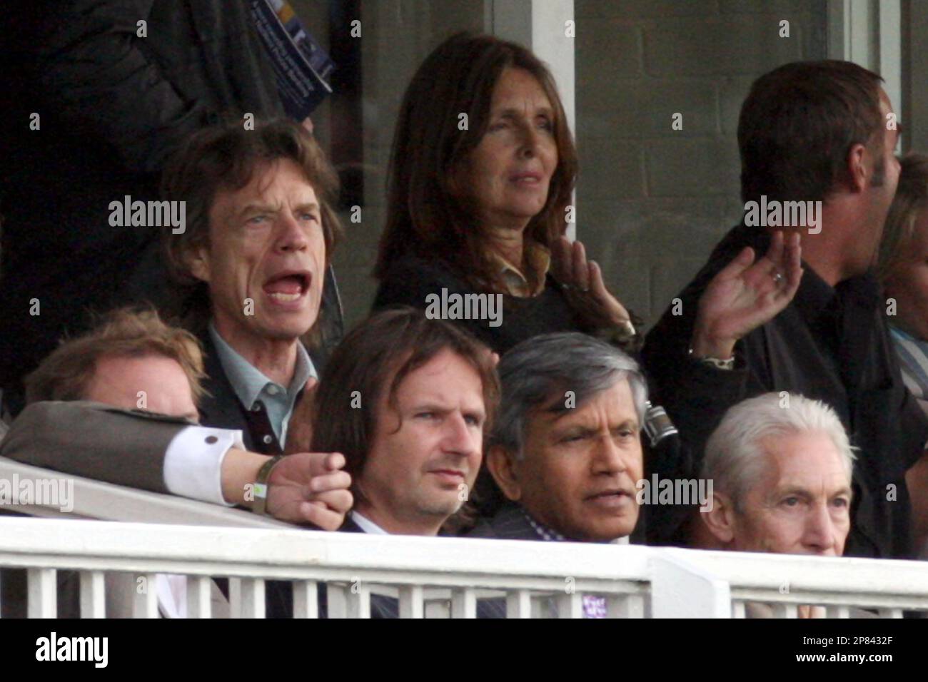 Mick Jagger, left, watches from the stands during the second one day ...