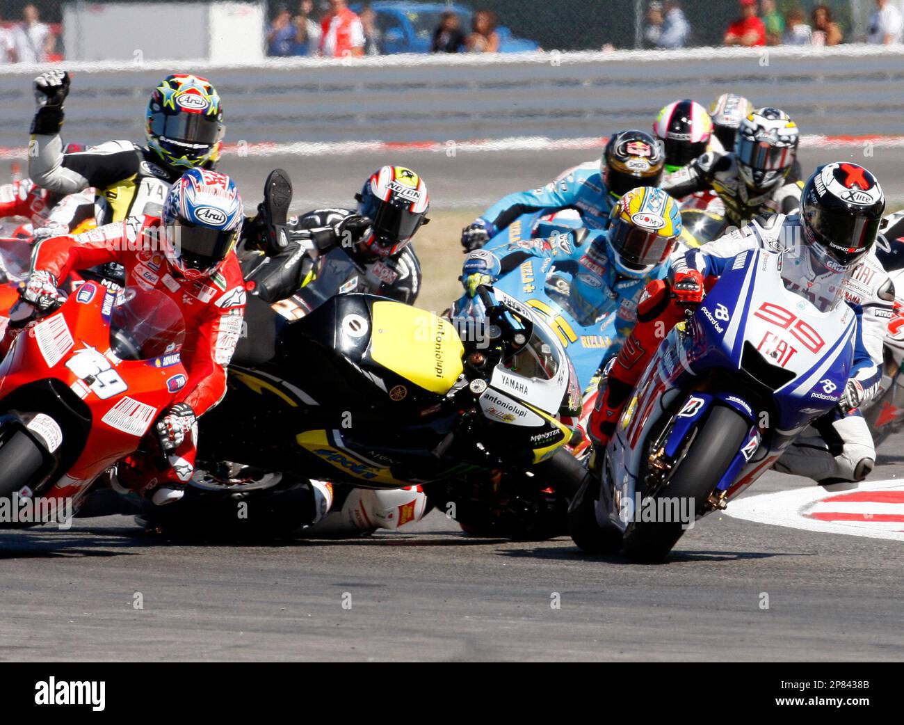 Italy's Alex De Angelis, right, and Colin Edwards, top left, of the ...
