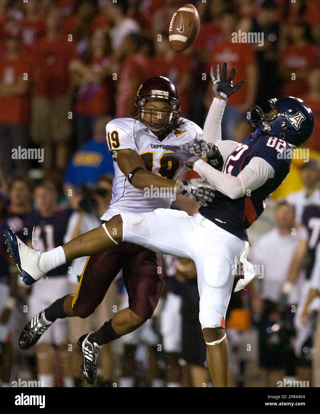 Arizona's Juron Criner (82) and Central Michigan's Josh Gordy (19) both ...
