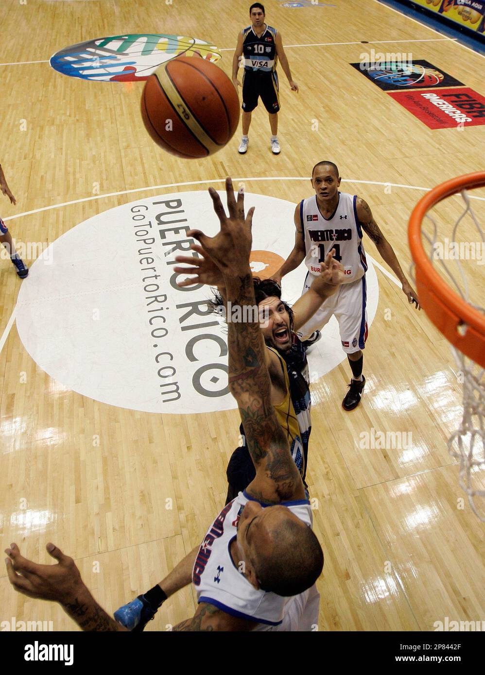 Puerto Rico's Peter John Ramos, below, blocks a shot of Argentina's ...
