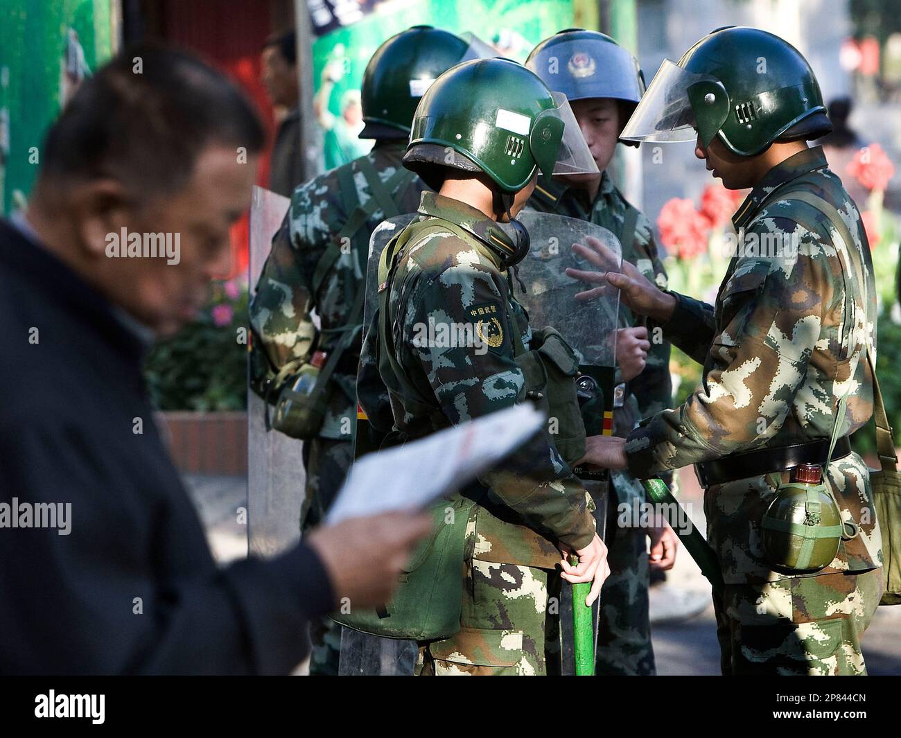 Chinese paramilitary police officers prepare for their patrol as they ...