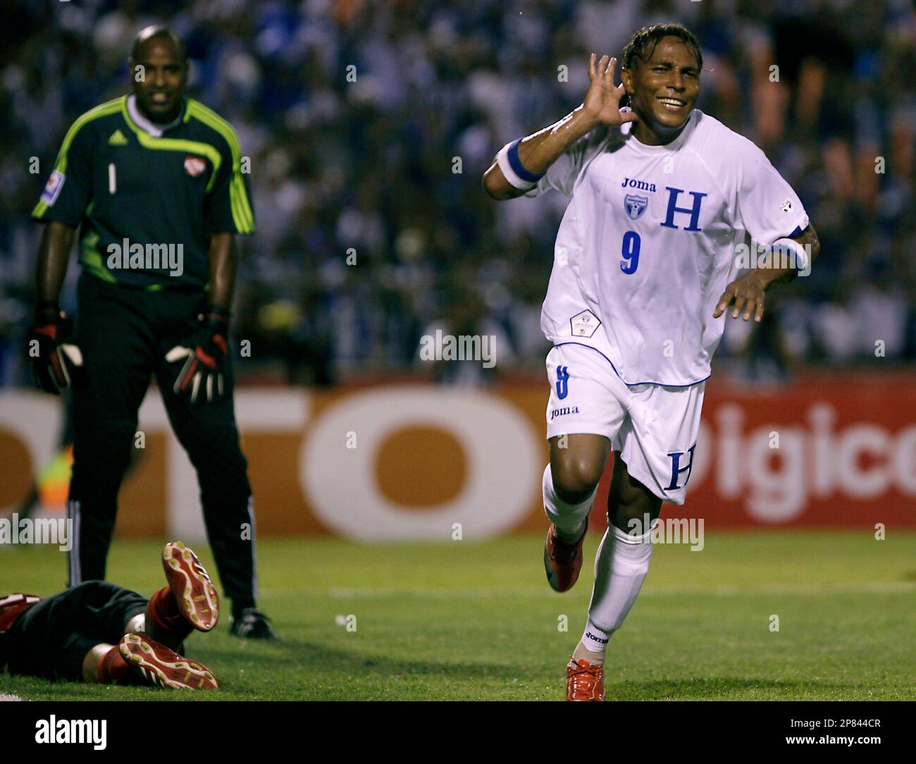 Hondura's Carlos Pavon celebrates after scoring as Trinidad & Tobago's ...