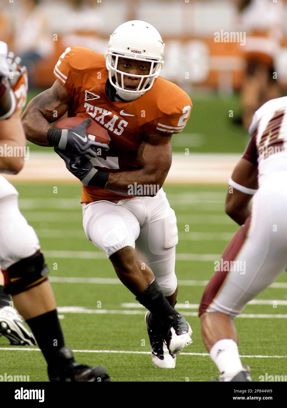 Texas running back Vondrell McGee, center, runs between Louisiana ...