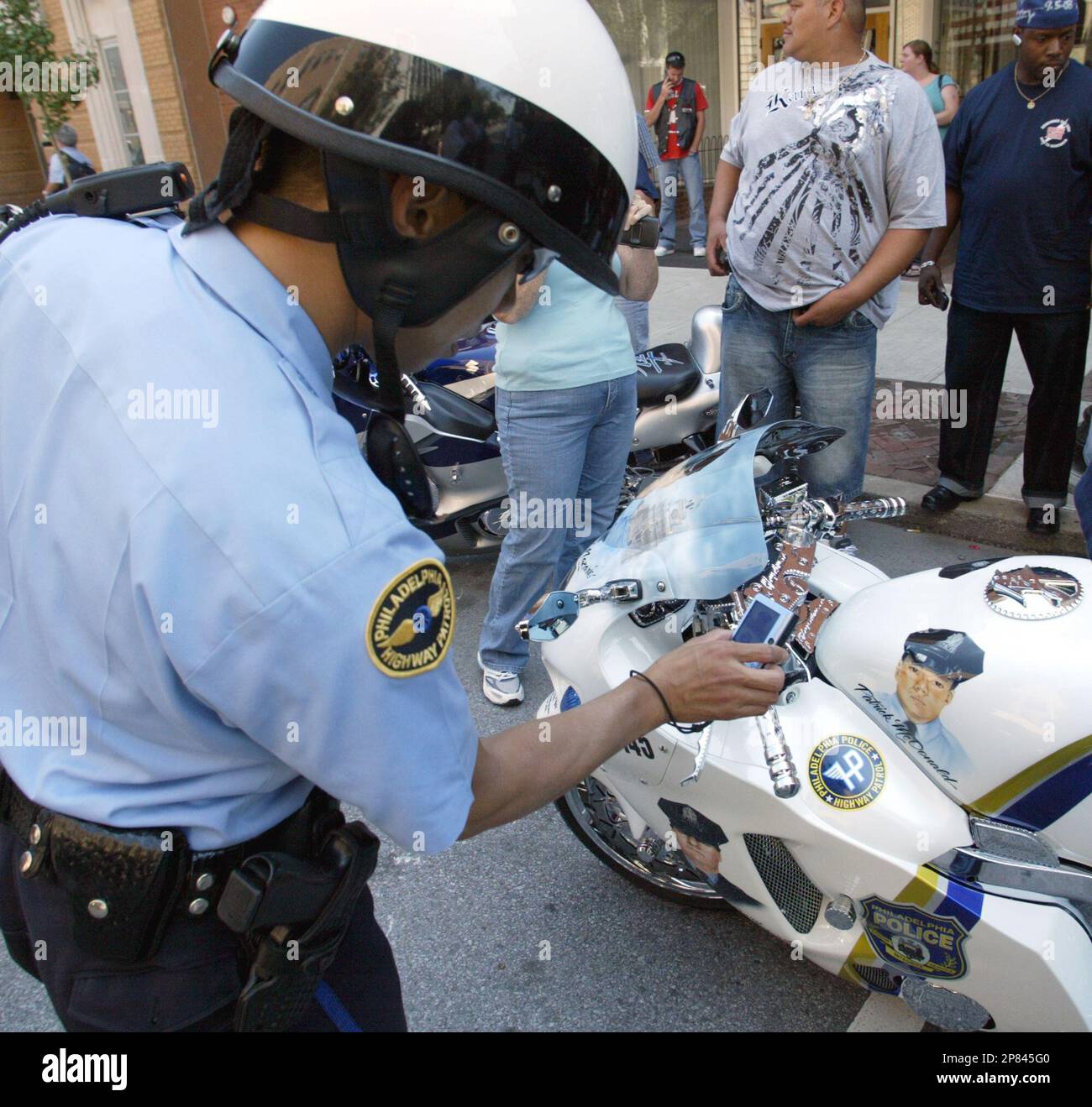 Philadelphia Highway Patrol Officer Andy Chan takes a picture of a ...