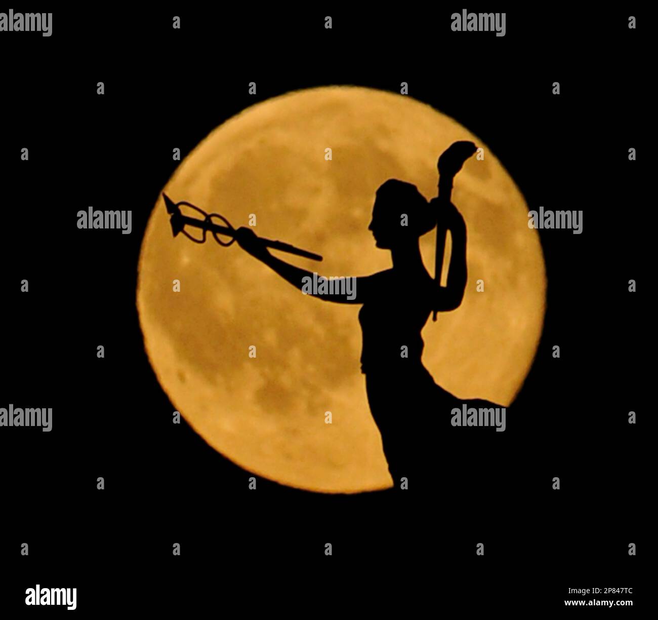 The full moon rises behind The 1930 art deco sculpture "Spirit of ...