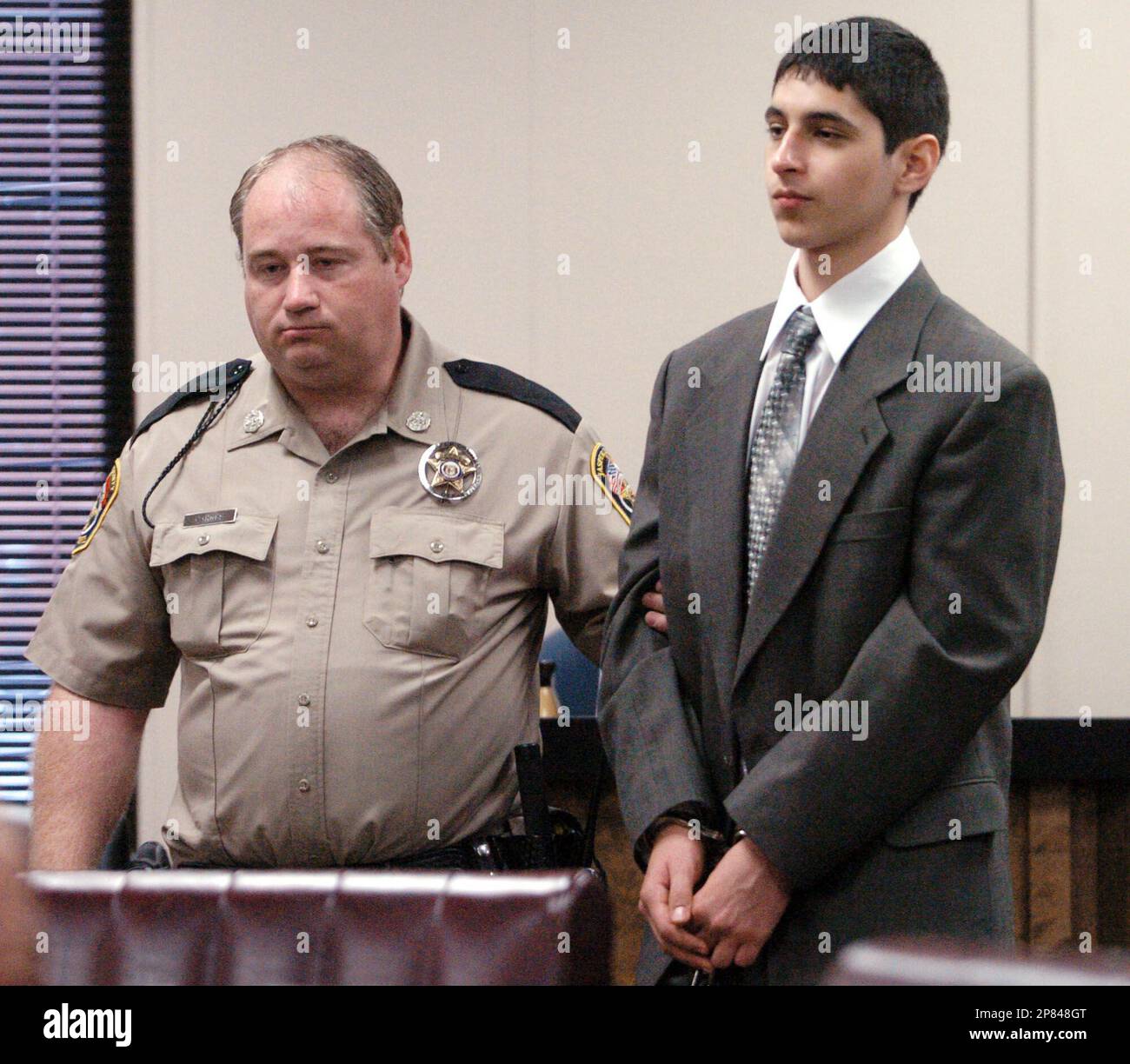 Thomas White, right, of Joplin, is escorted out of the Joplin Courts ...