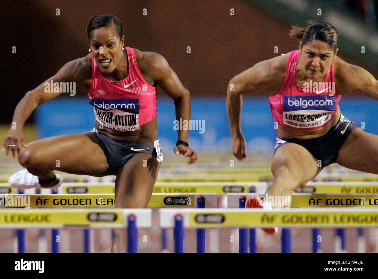 Brigitte Foster-Hylton, left, from Jamaica wins the 100 meter hurdles ...