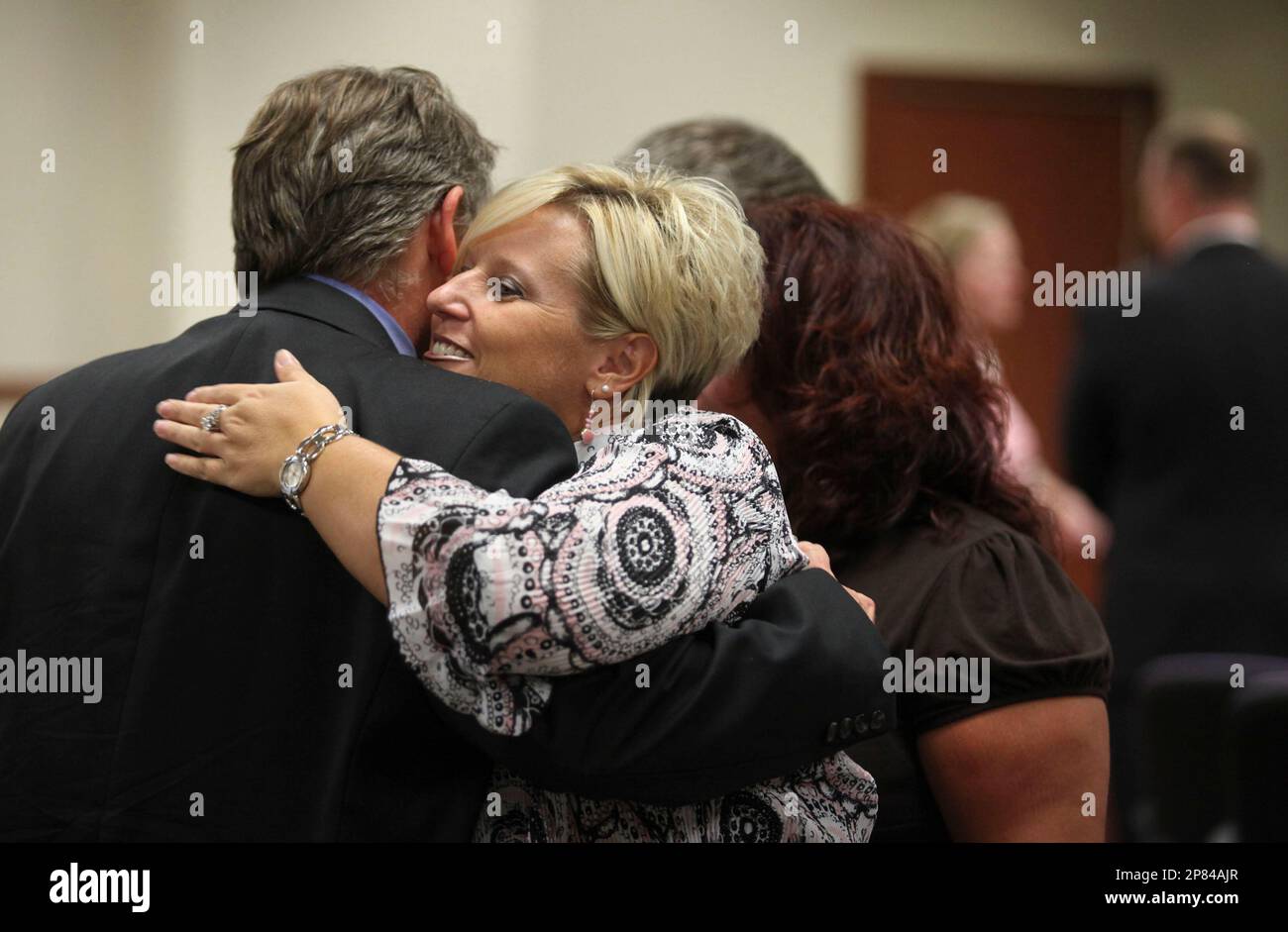 Monica Stinson gets a hug from a well-wisher after the first day of her ...