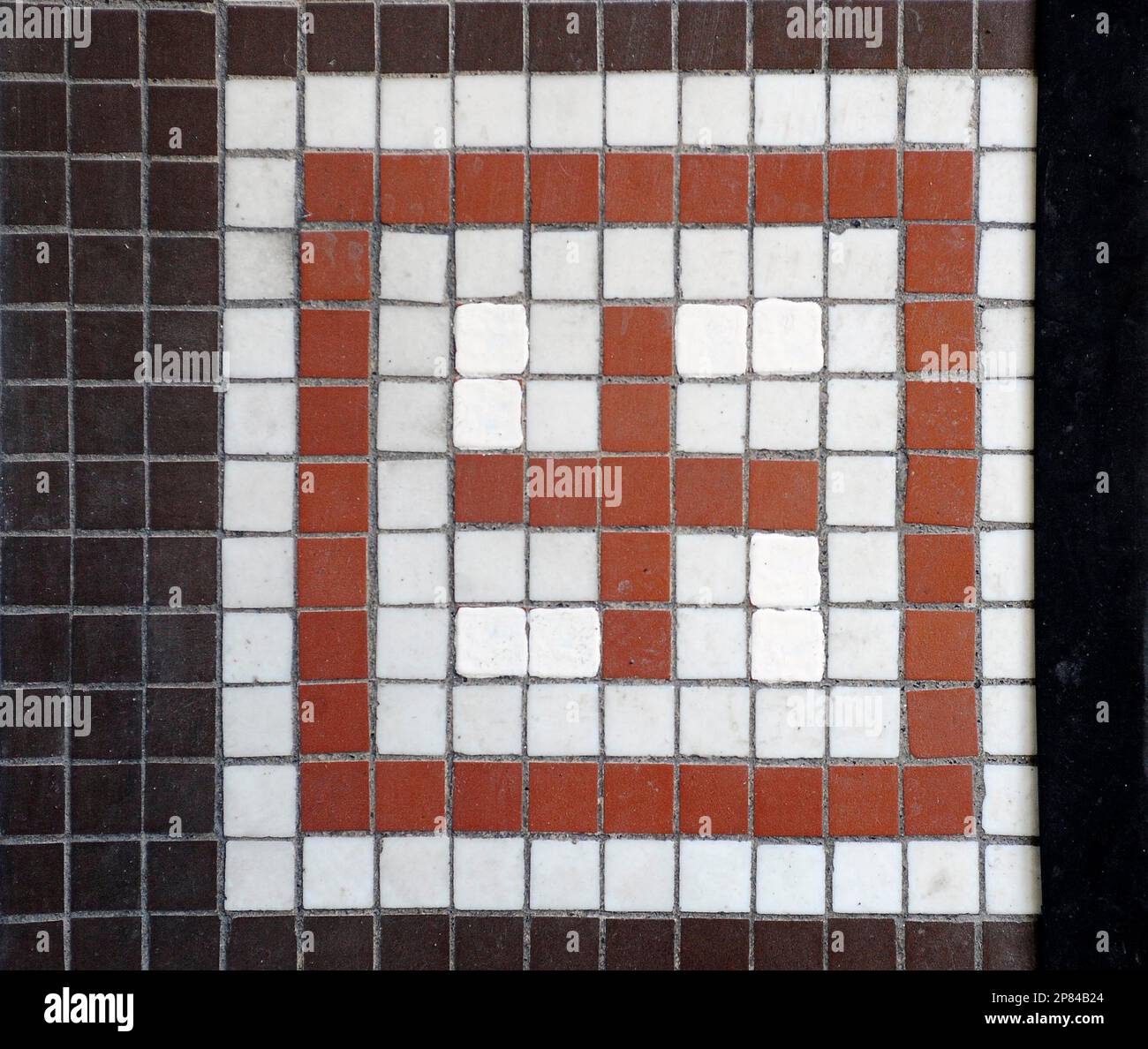 A tile design originally showing a swastika is painted over to on the ...