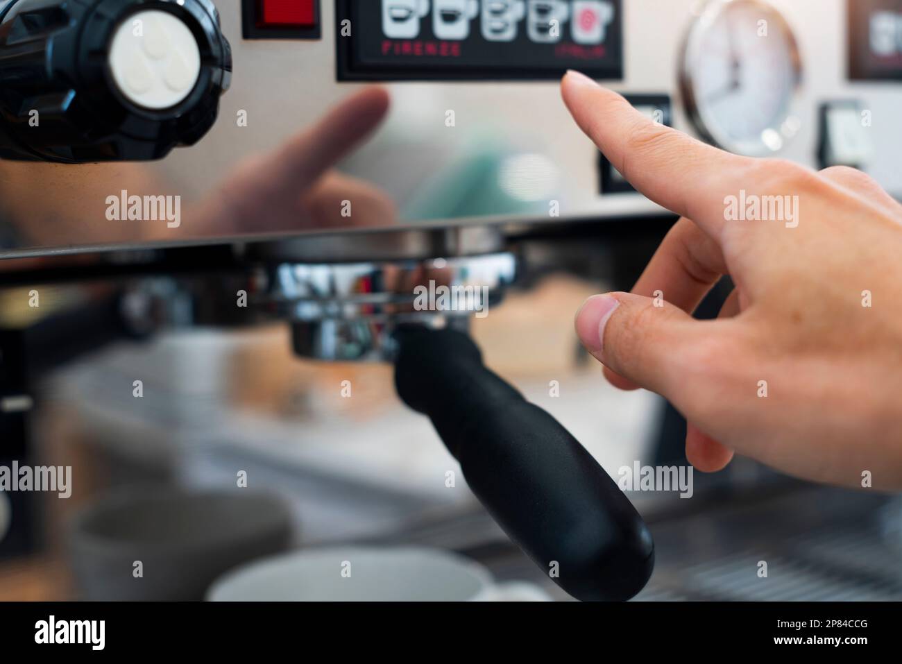 hand barista man press the button switch on espresso machine before ...