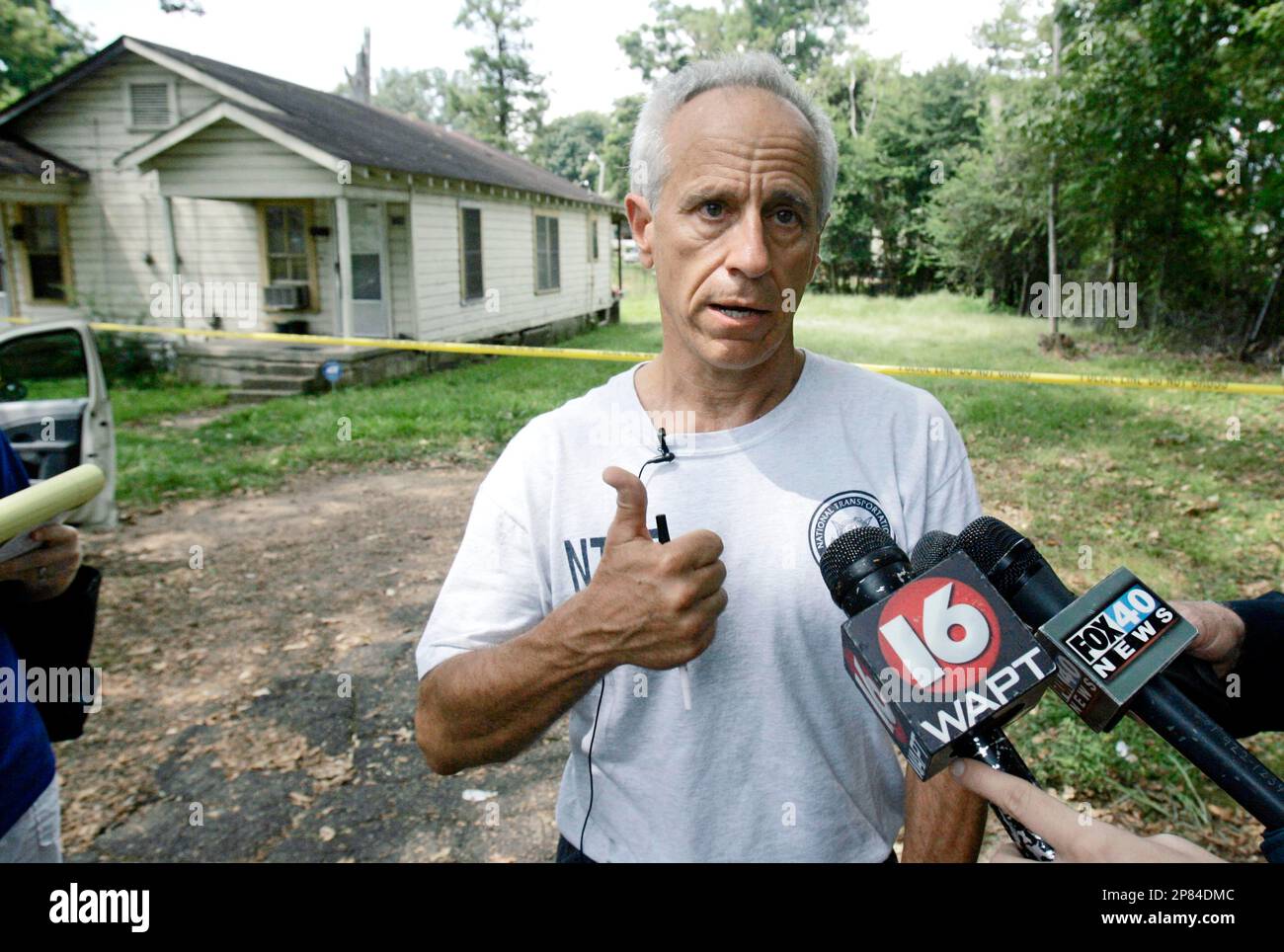 National Transportation Safety Board investigator Mike Huhn, standing ...