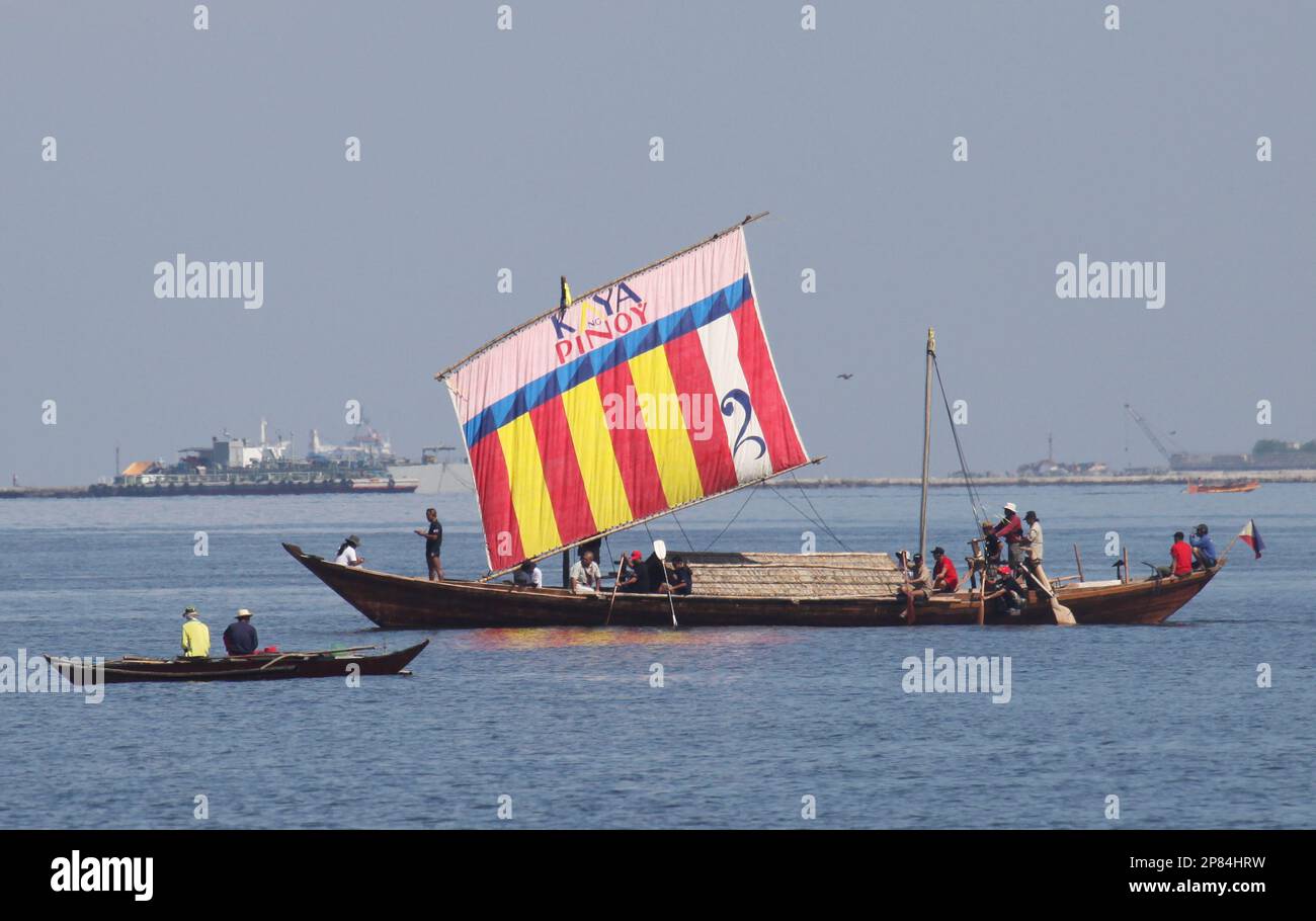 Filipino fishermen, left, watch as Filipino adventurers, some of whom ...