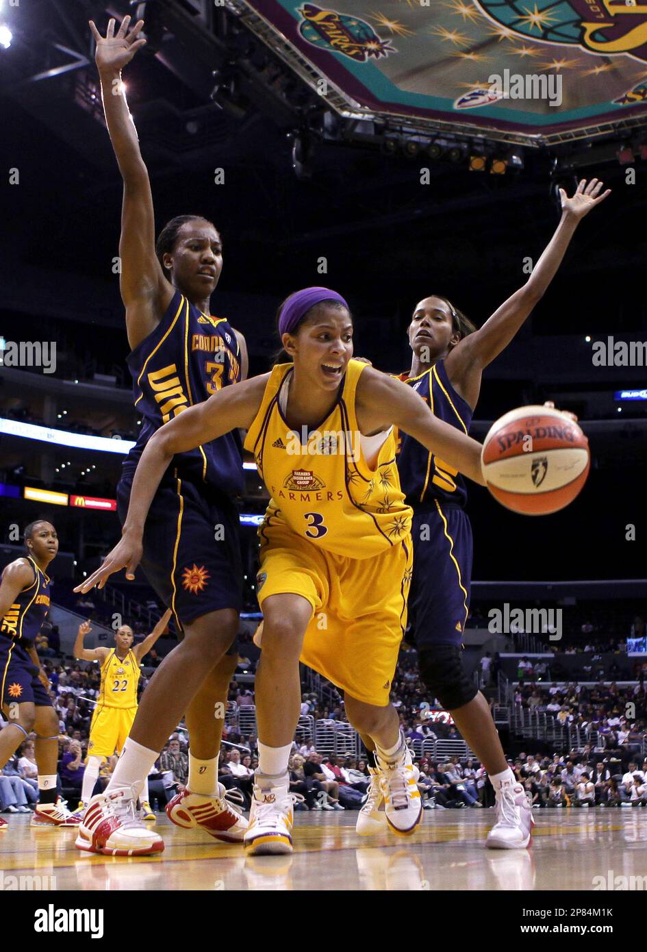 Los Angeles Sparks' Candace Parker (3) dribbles away from Connecticut Sun's Chante Black, left ...