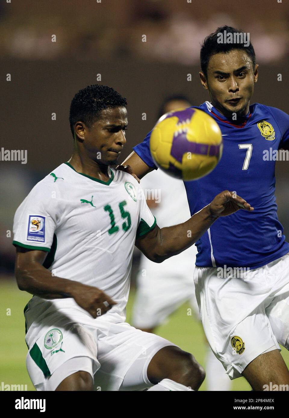 Saudi player Nasser Al-Shamrani , left, controls the ball against ...