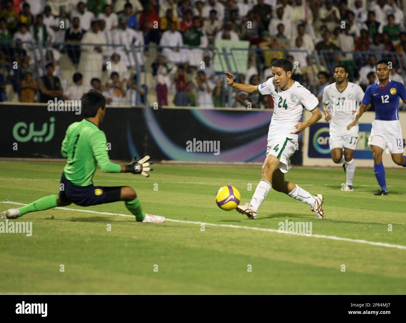 Saudi player Manaf Abushgeer, center, tries to scores against Malaysian ...