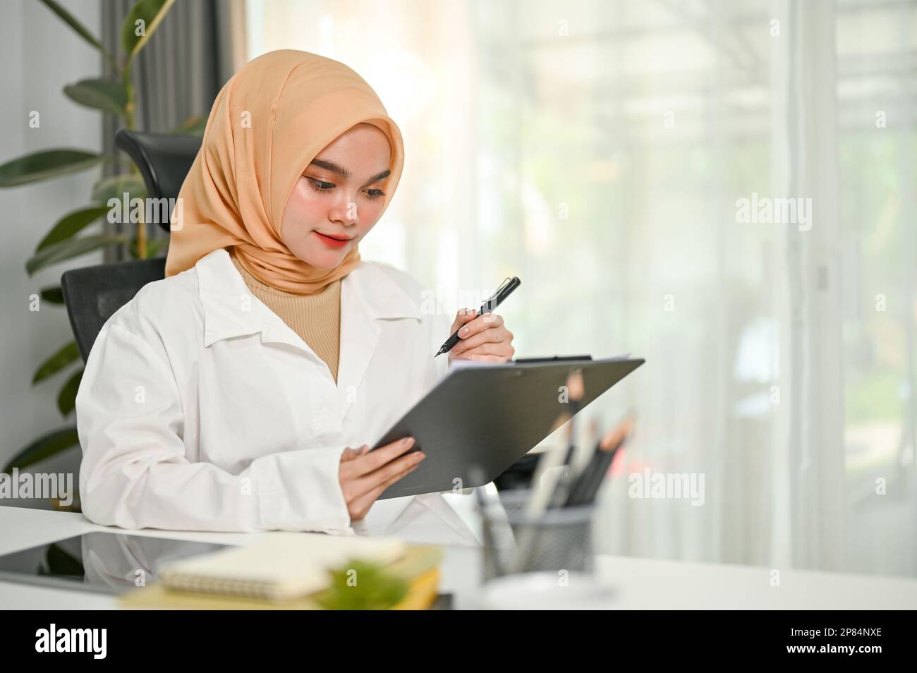 Successful millennial Asian Muslim businesswoman or female executive ...