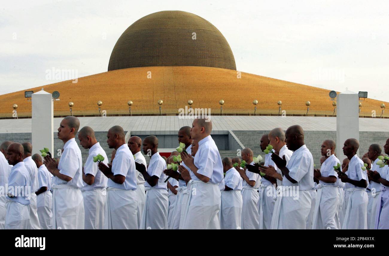 Ordinands chant prayers past the Golden Pagoda, background, during the ...