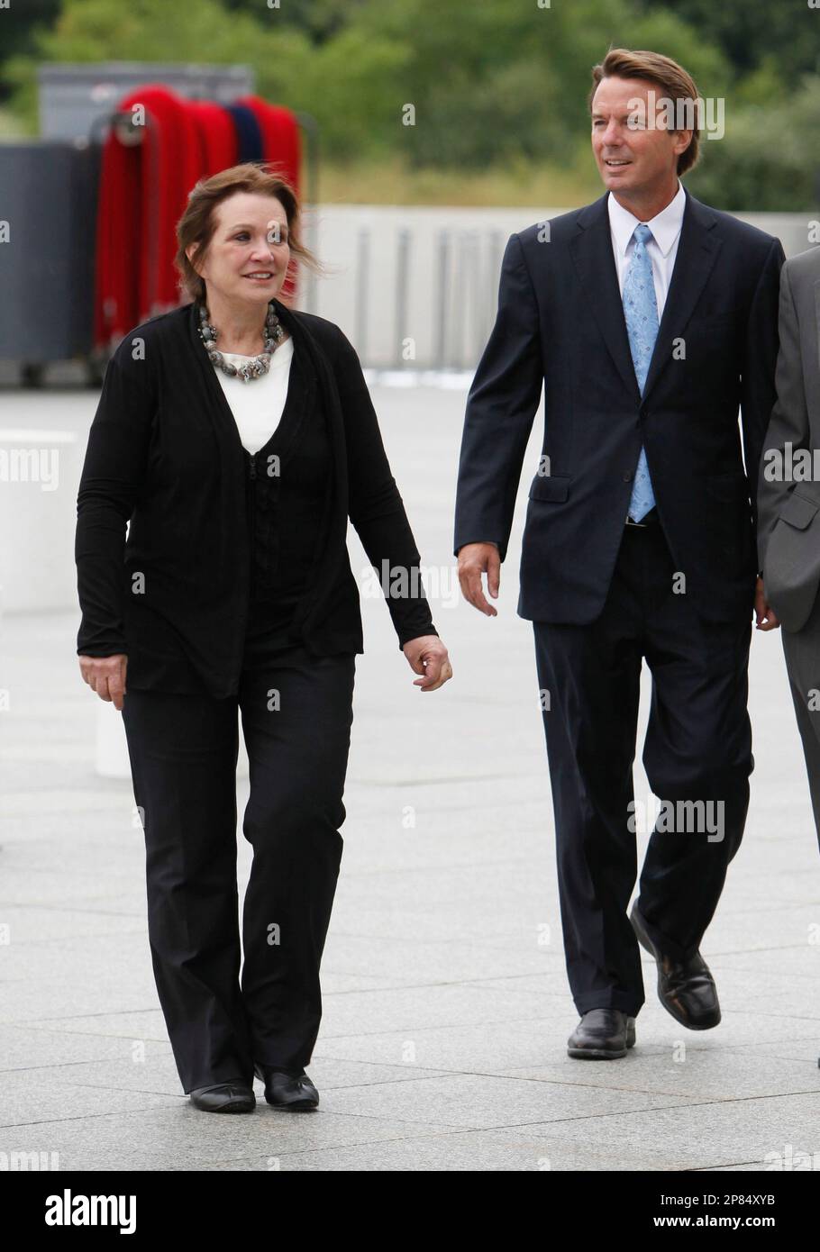 Former Sen. John Edwards, right, arrives with his wife Elizabeth for a ...