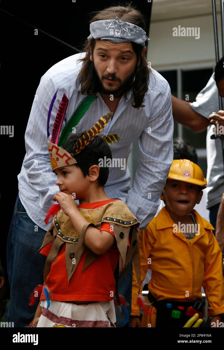 Mexican movie director Diego Luna adjusts the outfit of a child actor ...