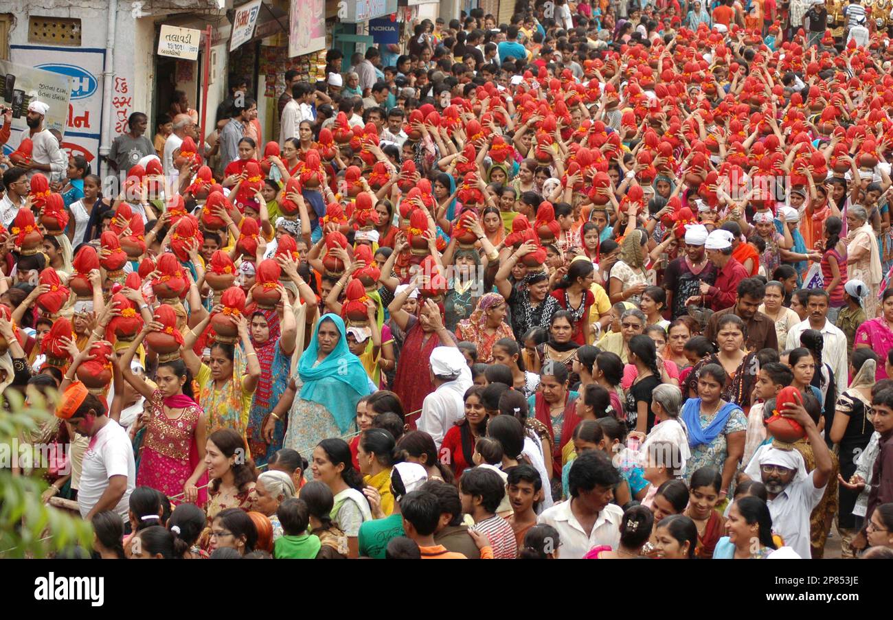 Devotees of Sindhi community carry earthen pots covered in red clothes ...