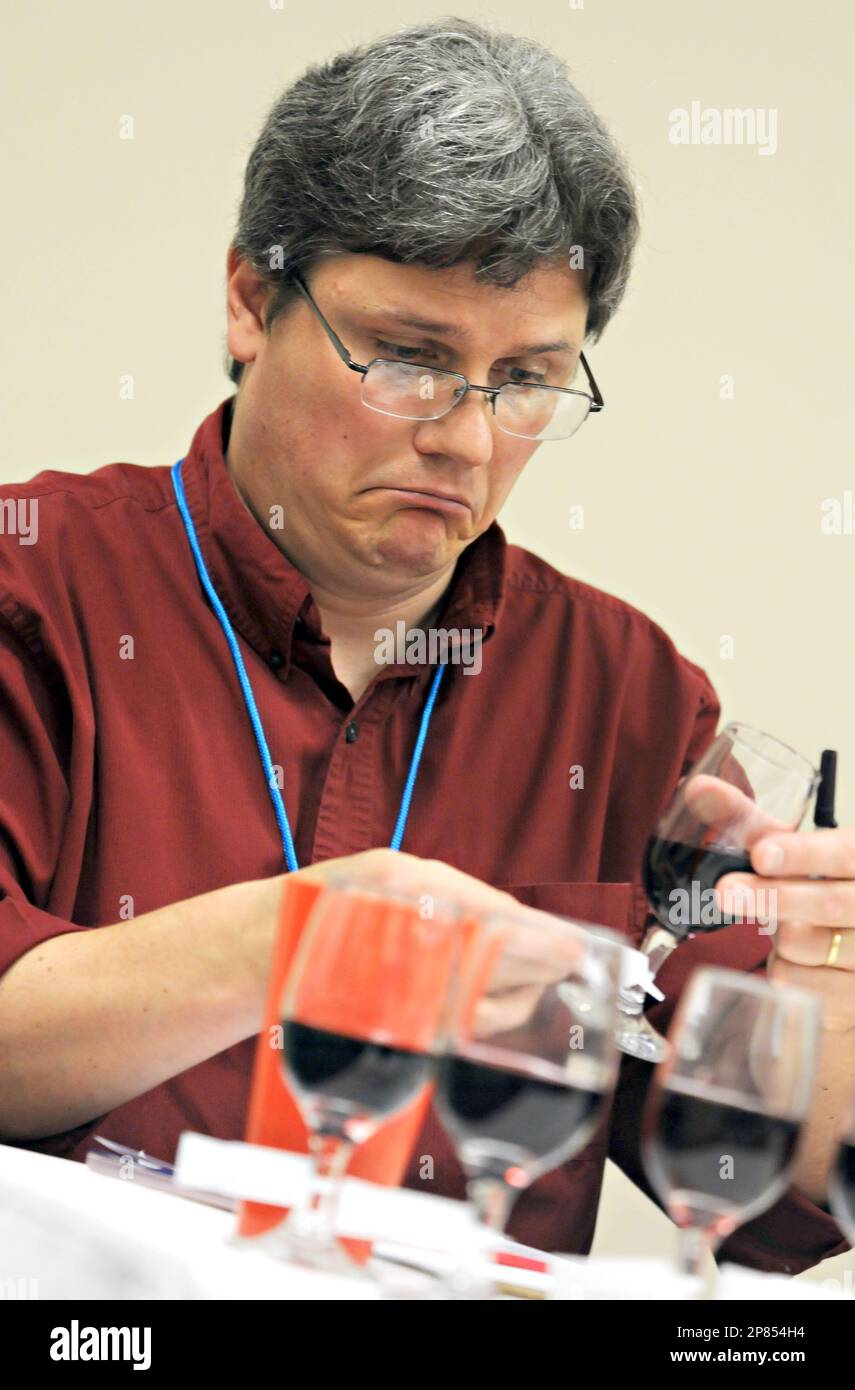 Wine expert Dave Kuennen examines the wine before tasting Tuesday, Aug ...