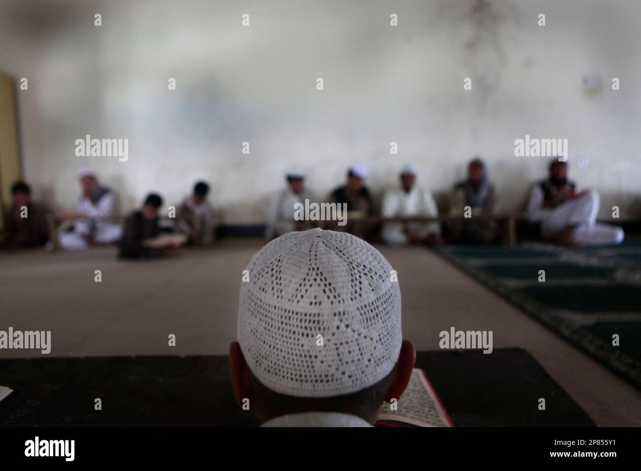 Afghan boys recite the Quran at a mosque on the outskirts of Kabul ...