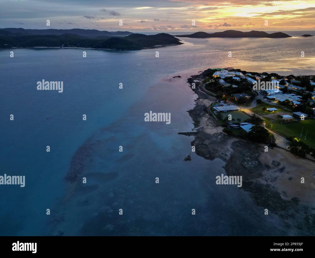 Aerial orange sunset showing the beach and town of Torres Strait Stock ...
