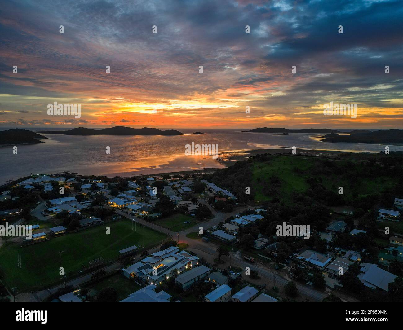 Aerial orange sunset showing the beach and town of Torres Strait Stock ...