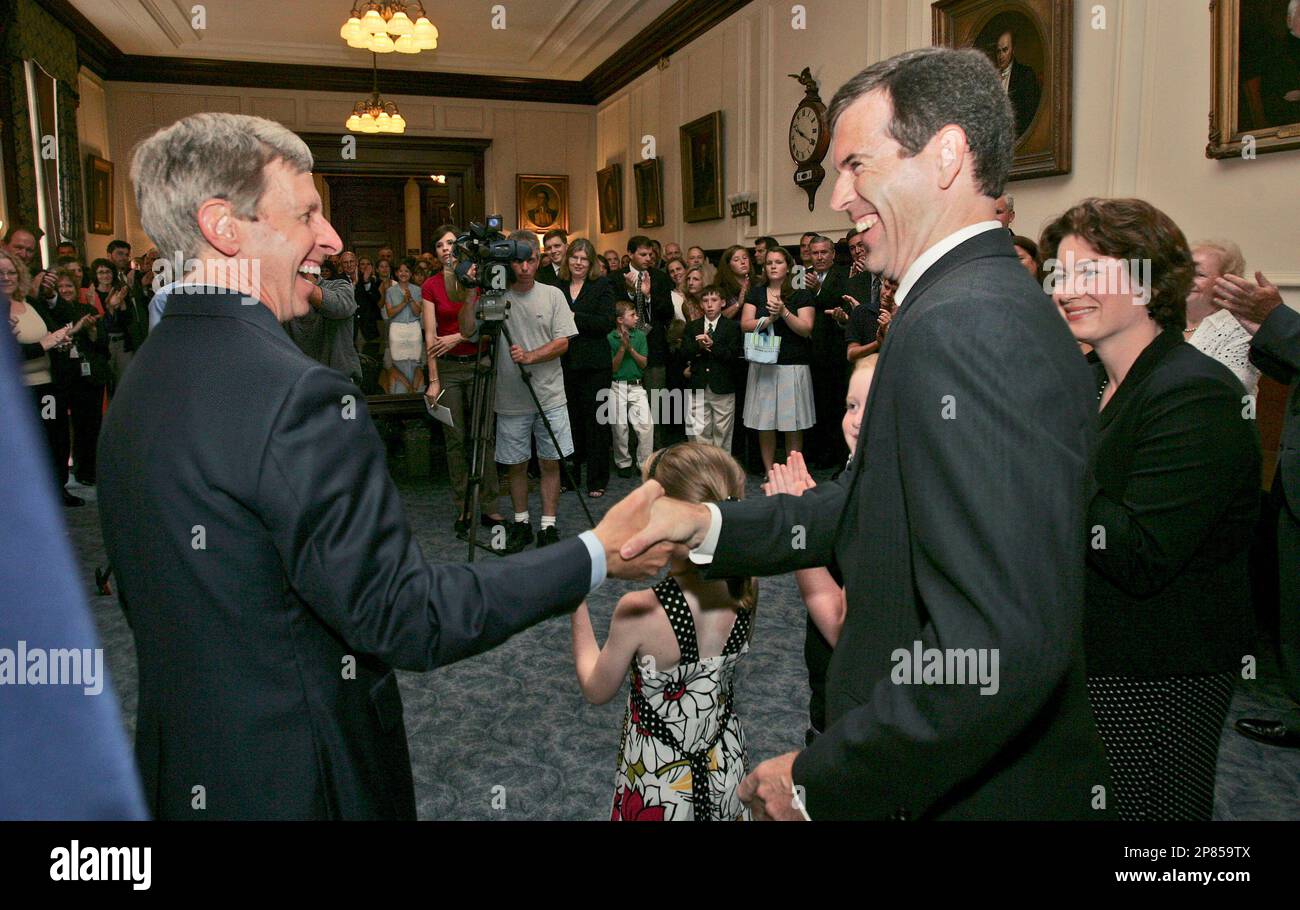 With his wife Caroline at his side, Michael Delaney shakes hands with ...
