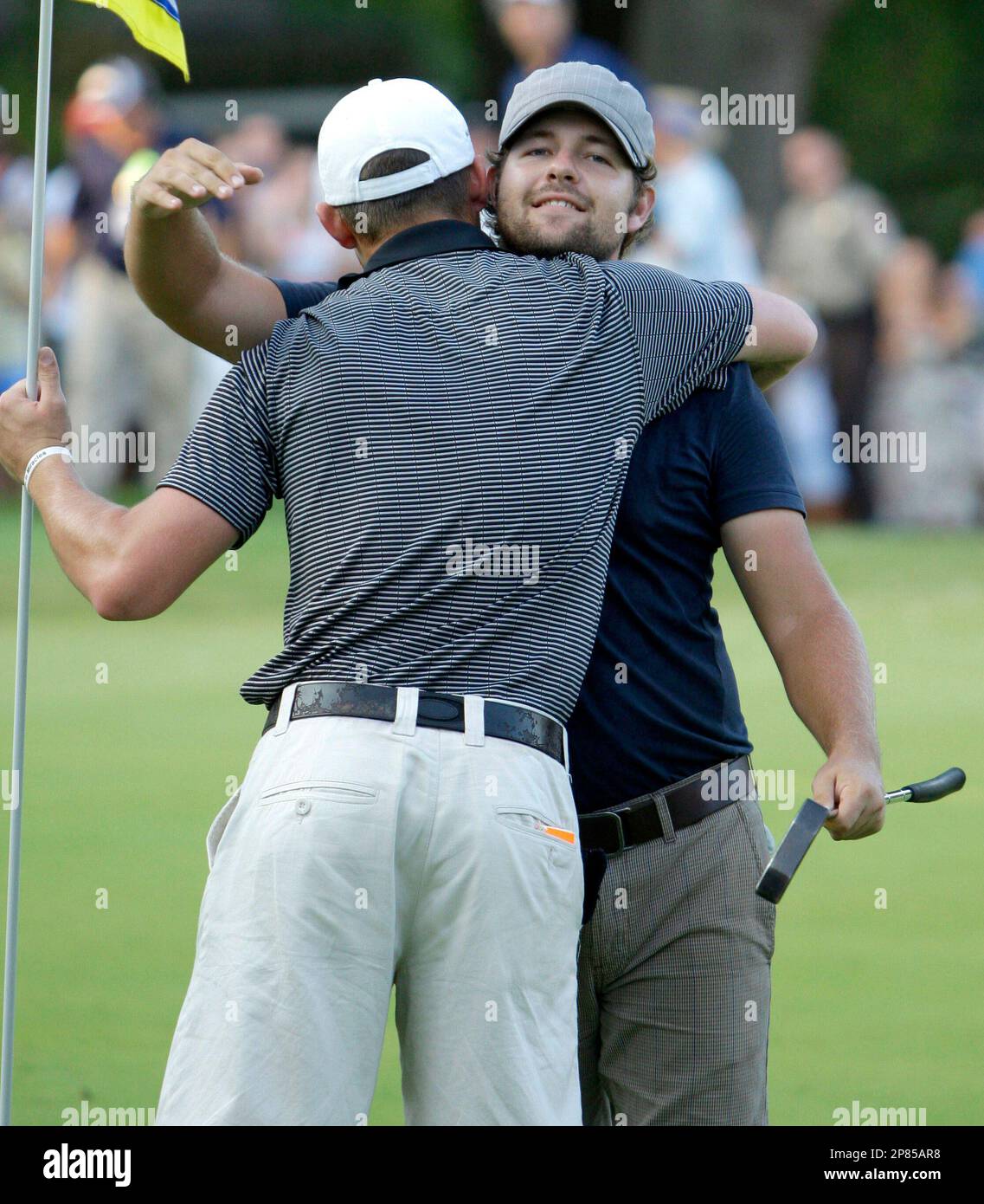 Ryan Moore, right, embraces his caddy after winning the Wyndham ...