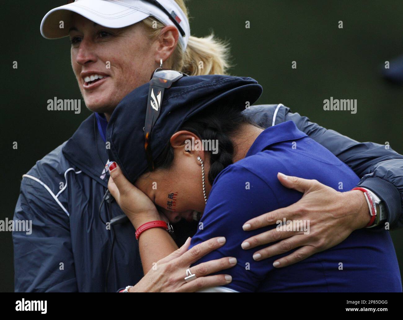 Team USA's Christina Kim is consoled by assistant captain Kelly Robbins ...