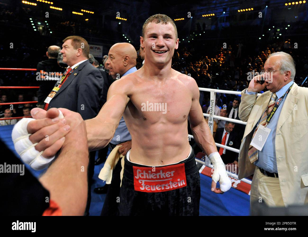 Germany's super middleweight boxer Robert Stieglitz, center, celebrates ...