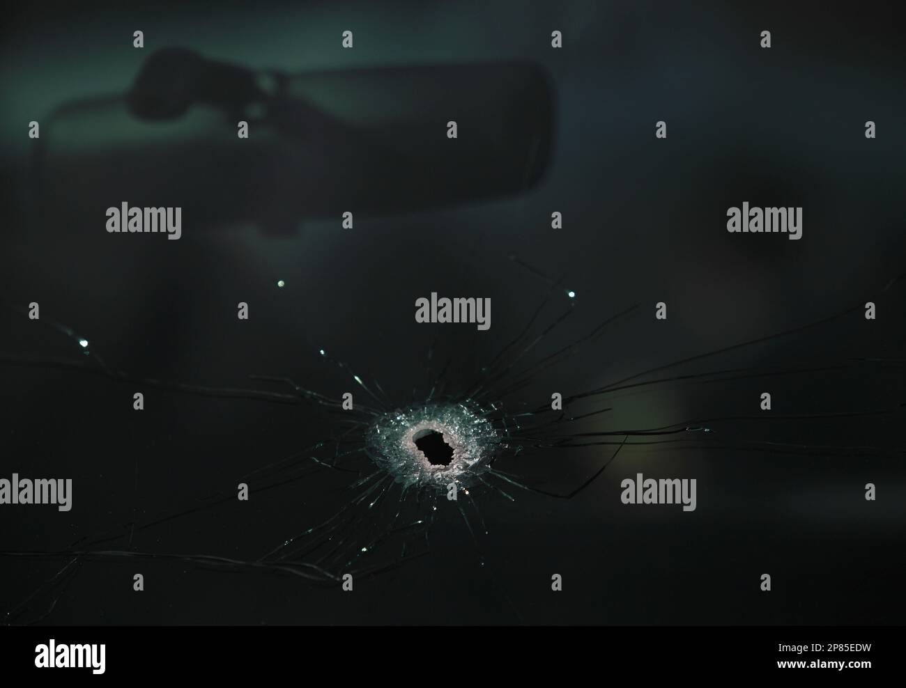 A bullet hole is seen on the windshield of a patrol at the site where ...