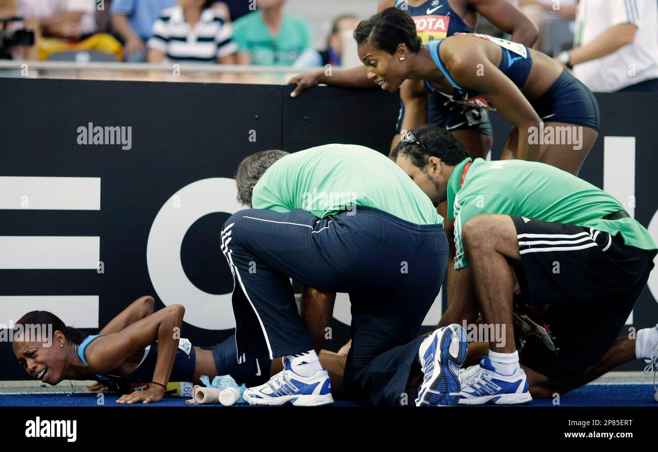United States' Alexandria Anderson, top, and medical staff attend to ...
