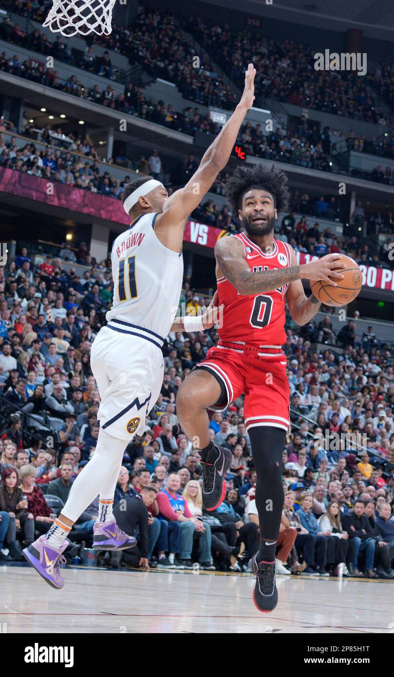 Chicago Bulls guard Coby White, right, drives to the rim as Denver ...