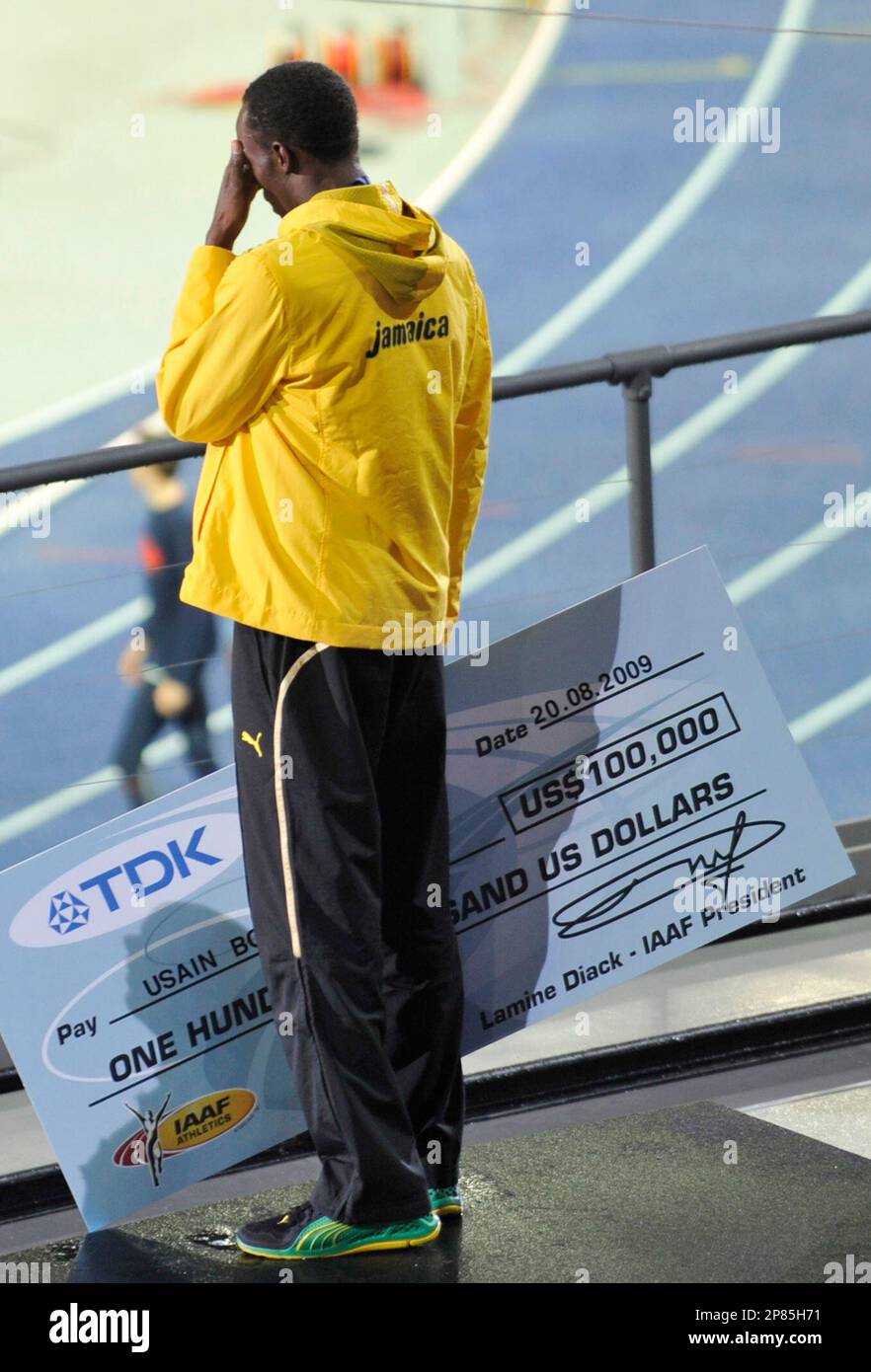 Jamaica's Usain Bolt, the gold medalist, reacts as the crowd sing ...