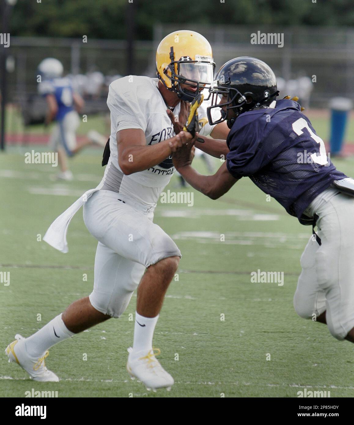 Fordson High School's senior wide receiver Baquer Sayed, left, blocks a ...