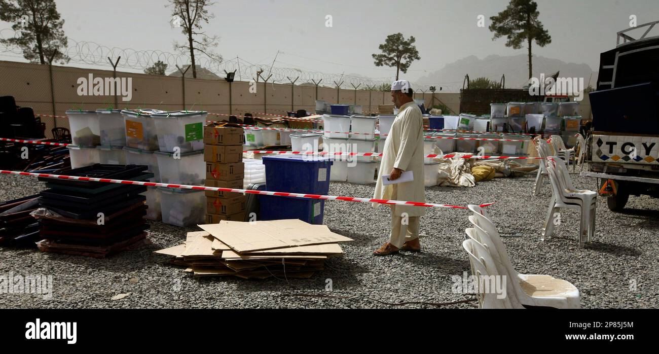 An Afghan worker of the election commission office inspects the ballot ...