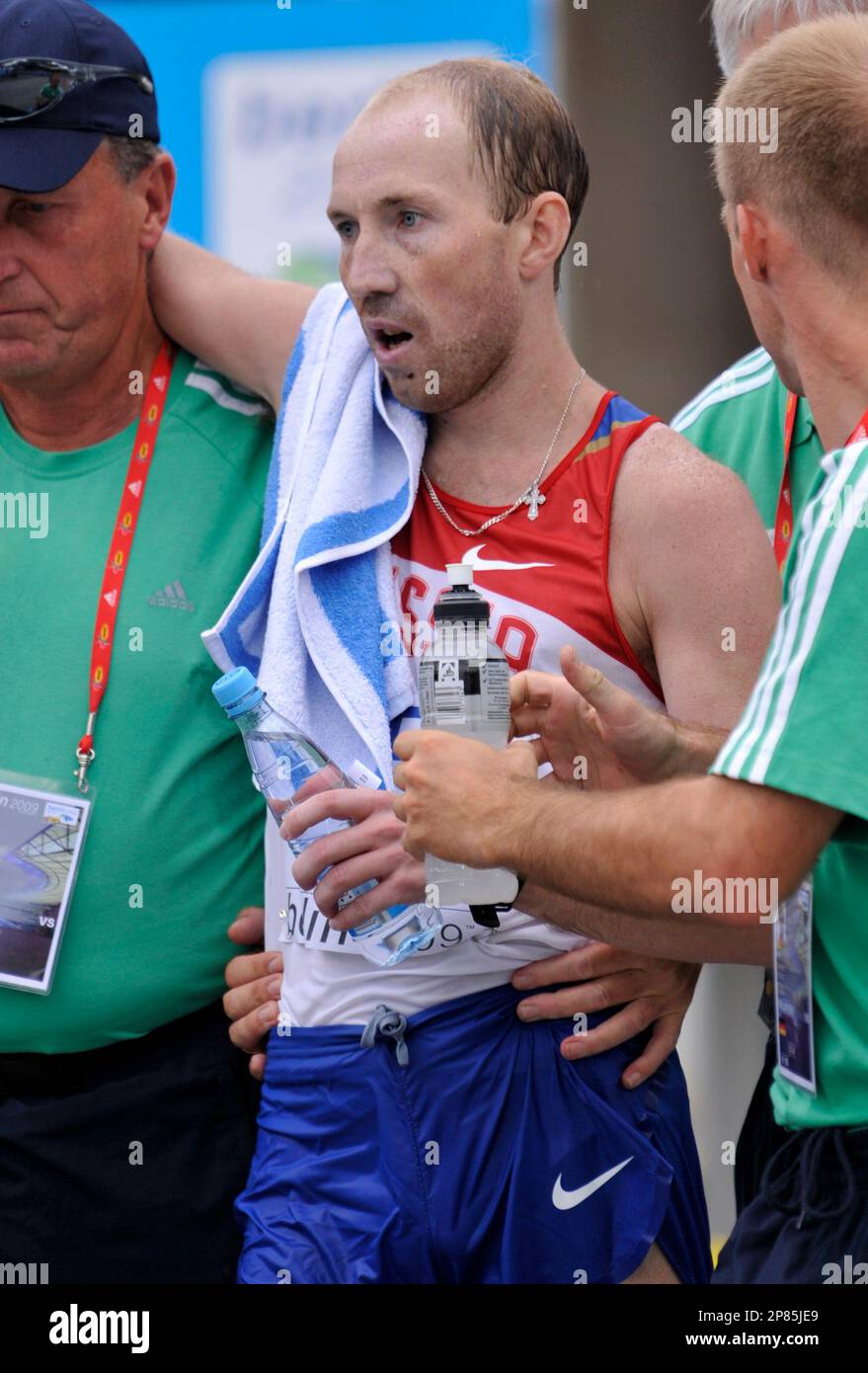 Russia's Sergey Kirdyapkin gets attendance after crossing the finish ...