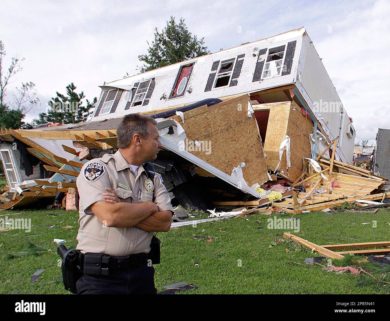 Loami Chief Police Officer Stan Workman surveys tornado damage in Loami ...