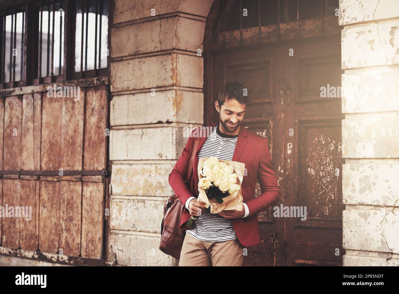 The class of a gentleman. a stylish young man holding a bouquet of ...