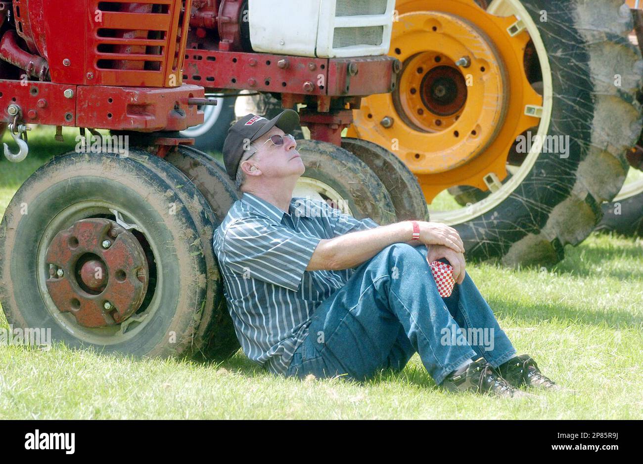 Bob Morrow of Newton, N.J., takes a nap on the front wheels of his ...