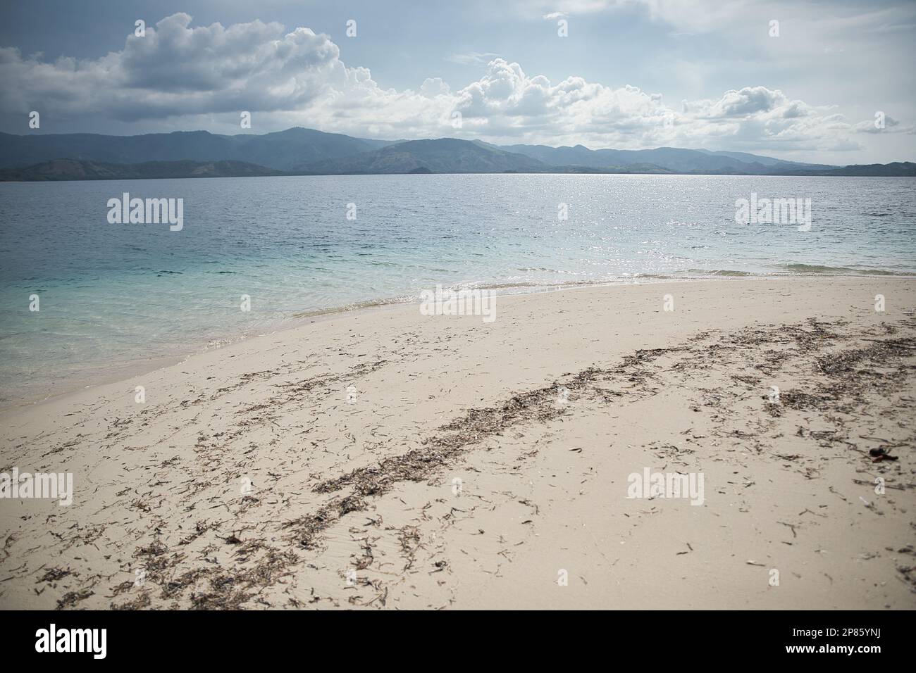 Paradisiacal shot of a white beach in Riung on Flores, with a range of ...